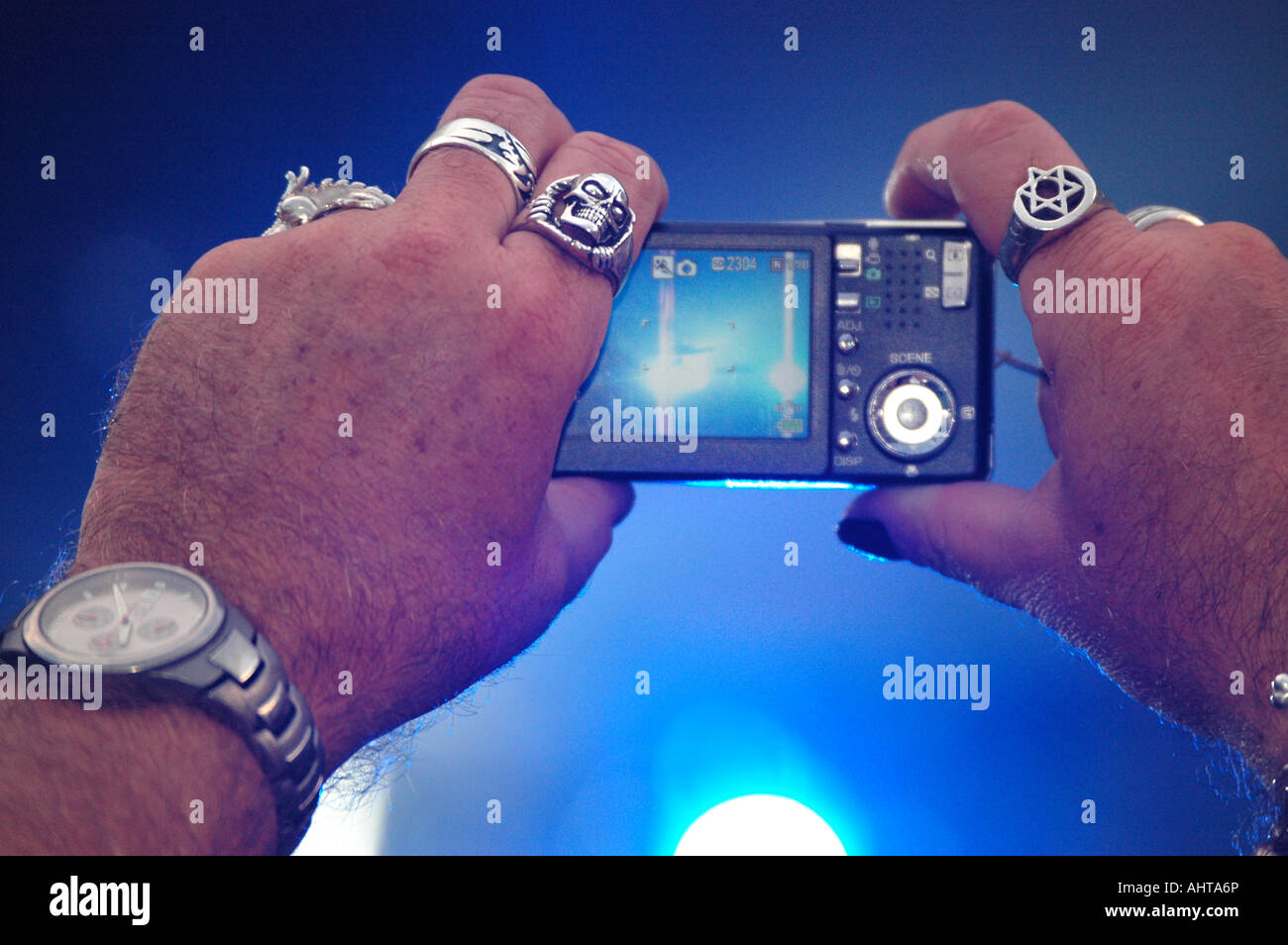 spectator taking snapshot at rock concert with digital camera Stock ...