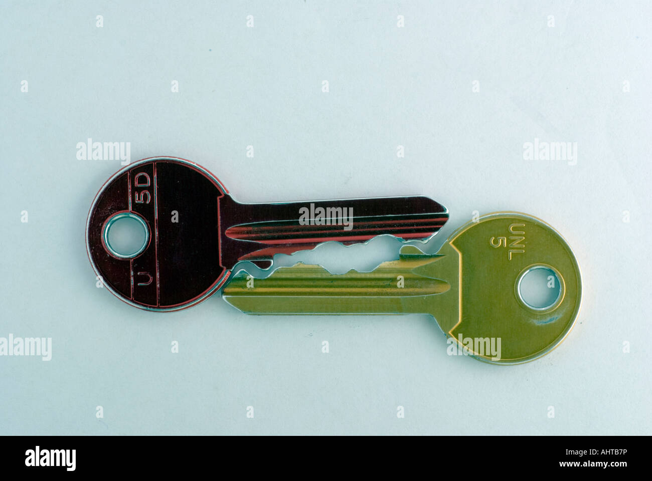 Two (gold key and red key) keys on white background Stock Photo - Alamy