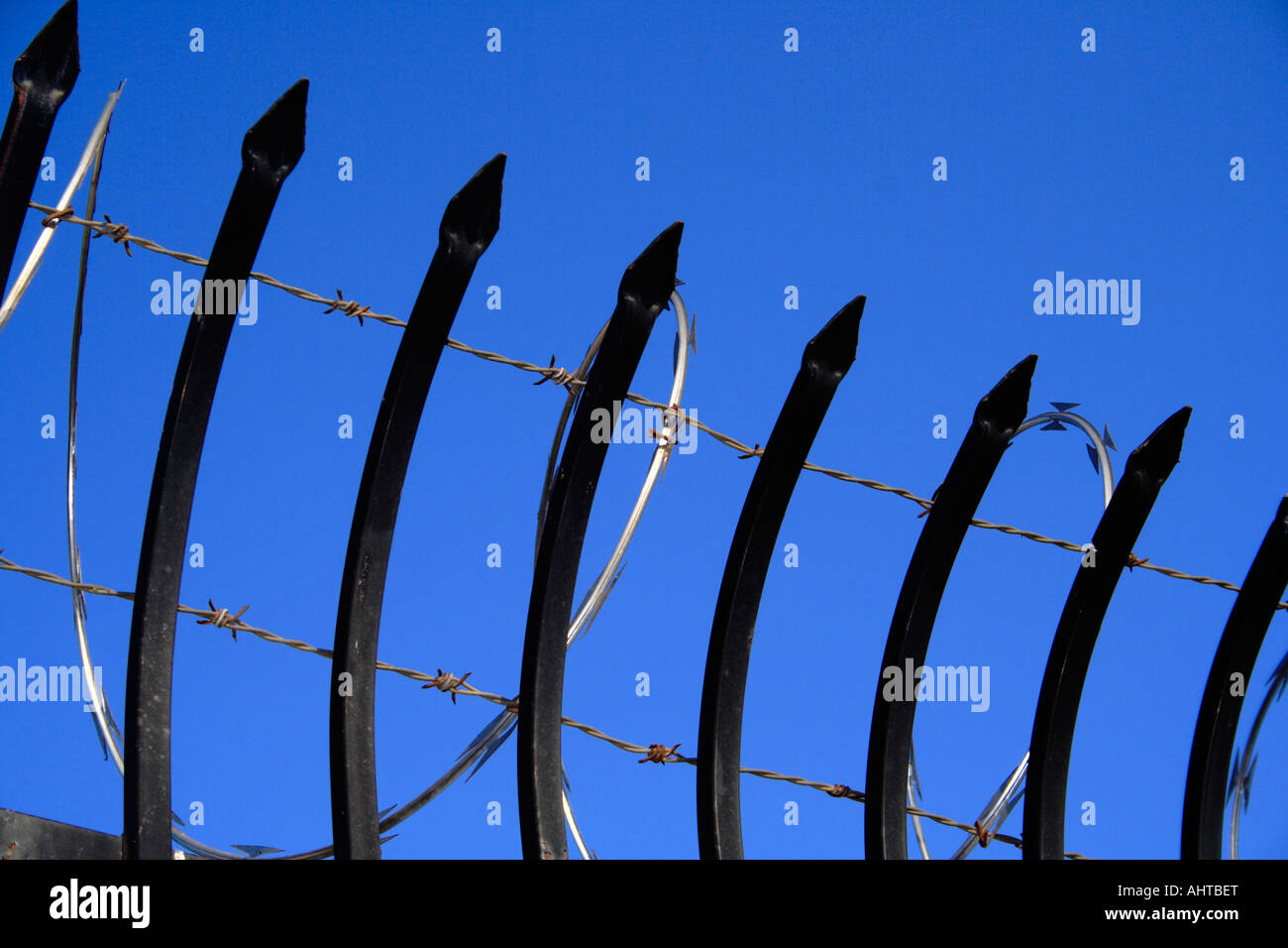 Security fence with razor wire Stock Photo - Alamy