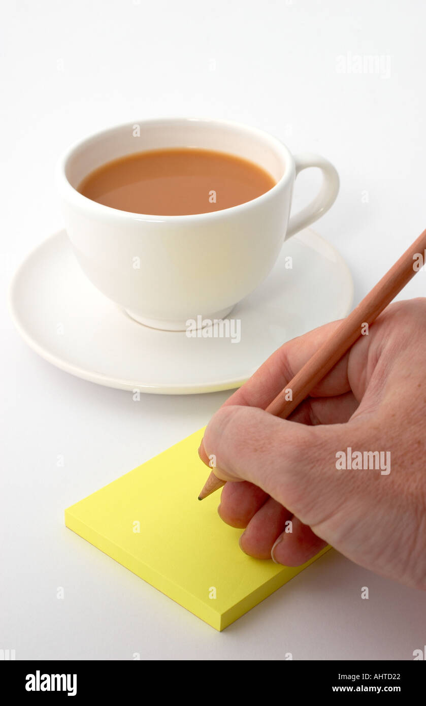 writing a post it note Stock Photo - Alamy