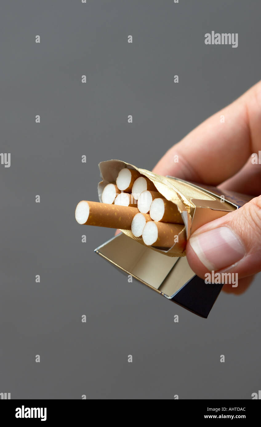 hand offering a packet of cigarettes Stock Photo - Alamy