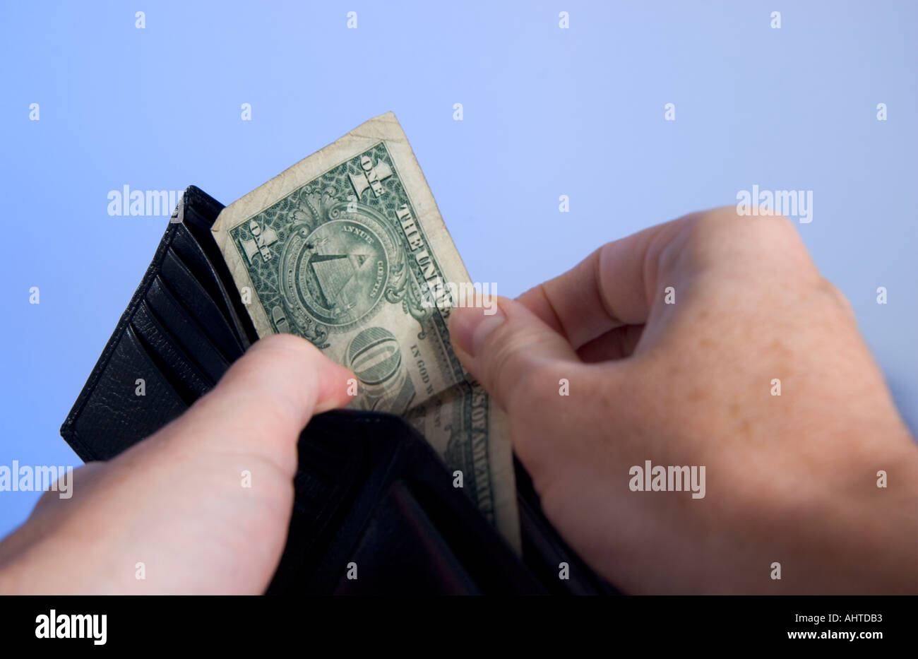 hand pulling a dollar bill from a wallet Stock Photo - Alamy