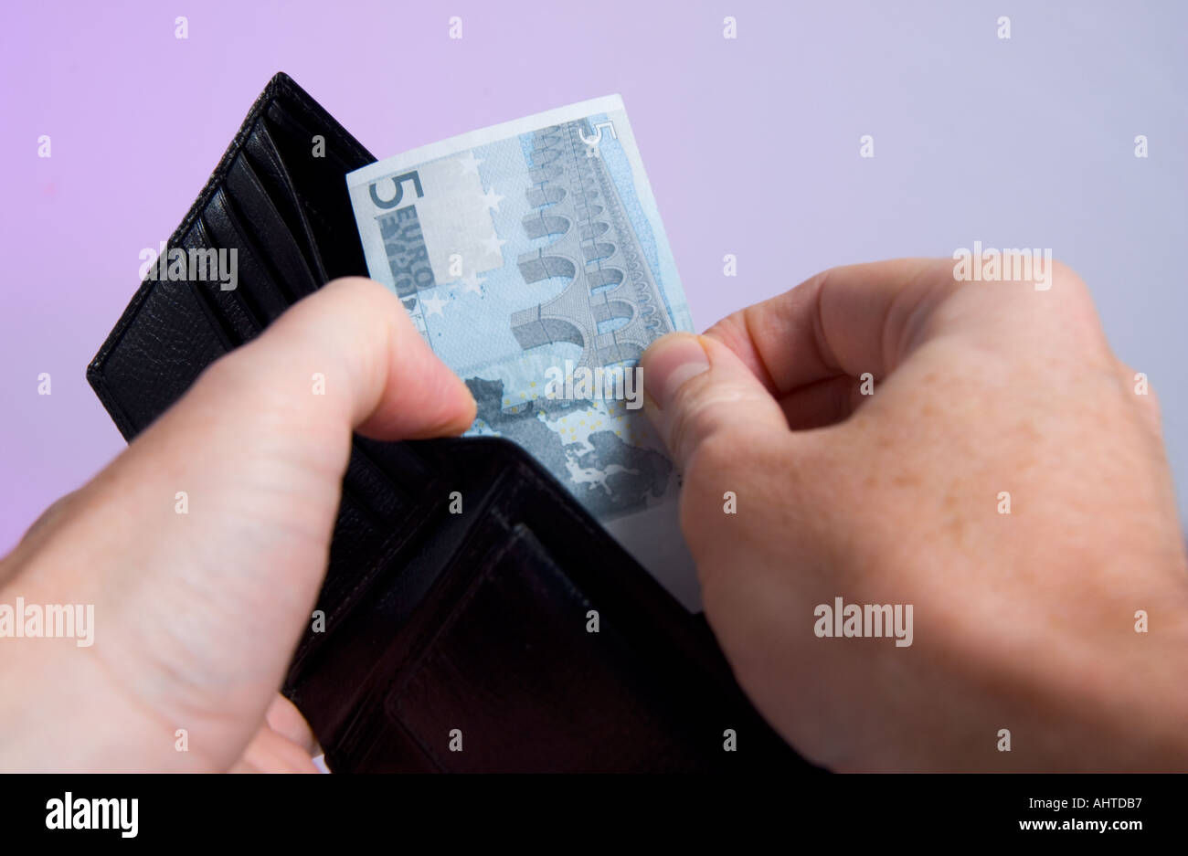 hand pulling a euro note from a wallet Stock Photo - Alamy