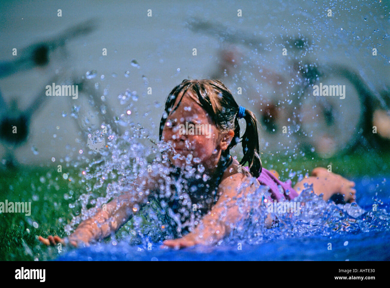 Girl on water slide hi-res stock photography and images - Alamy