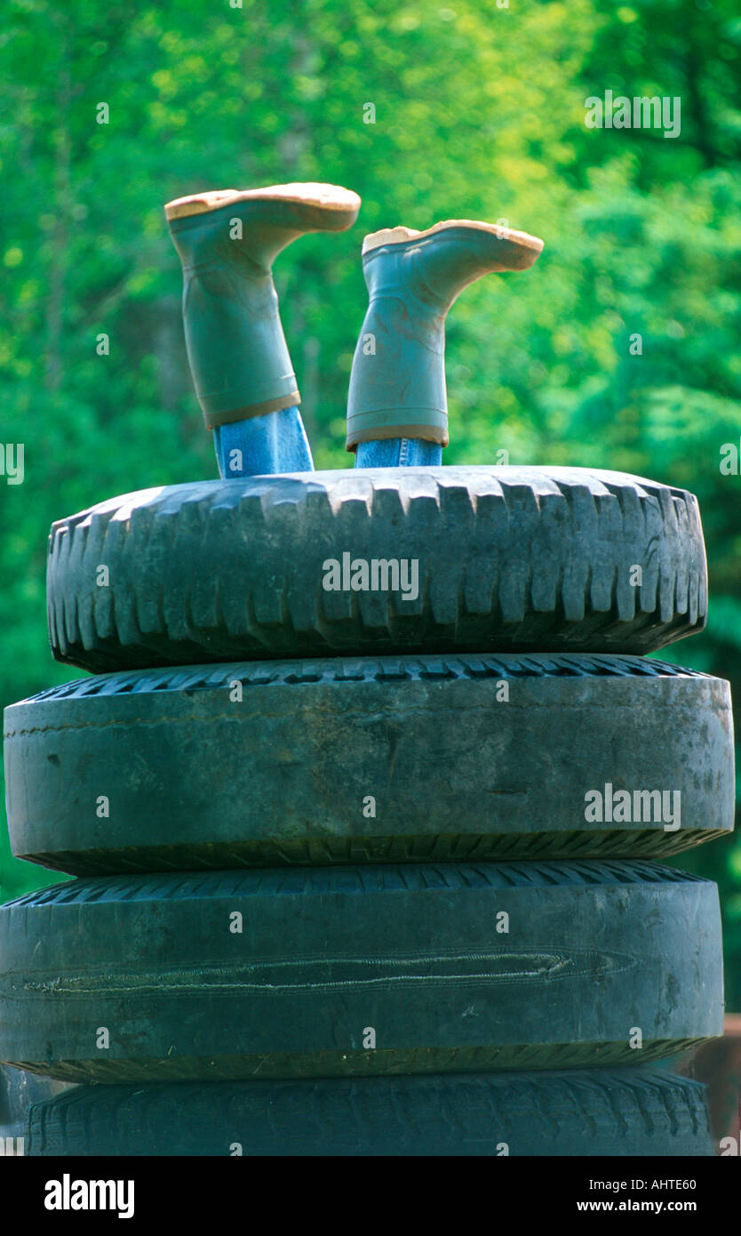 Boots in a tire 2 Stock Photo - Alamy