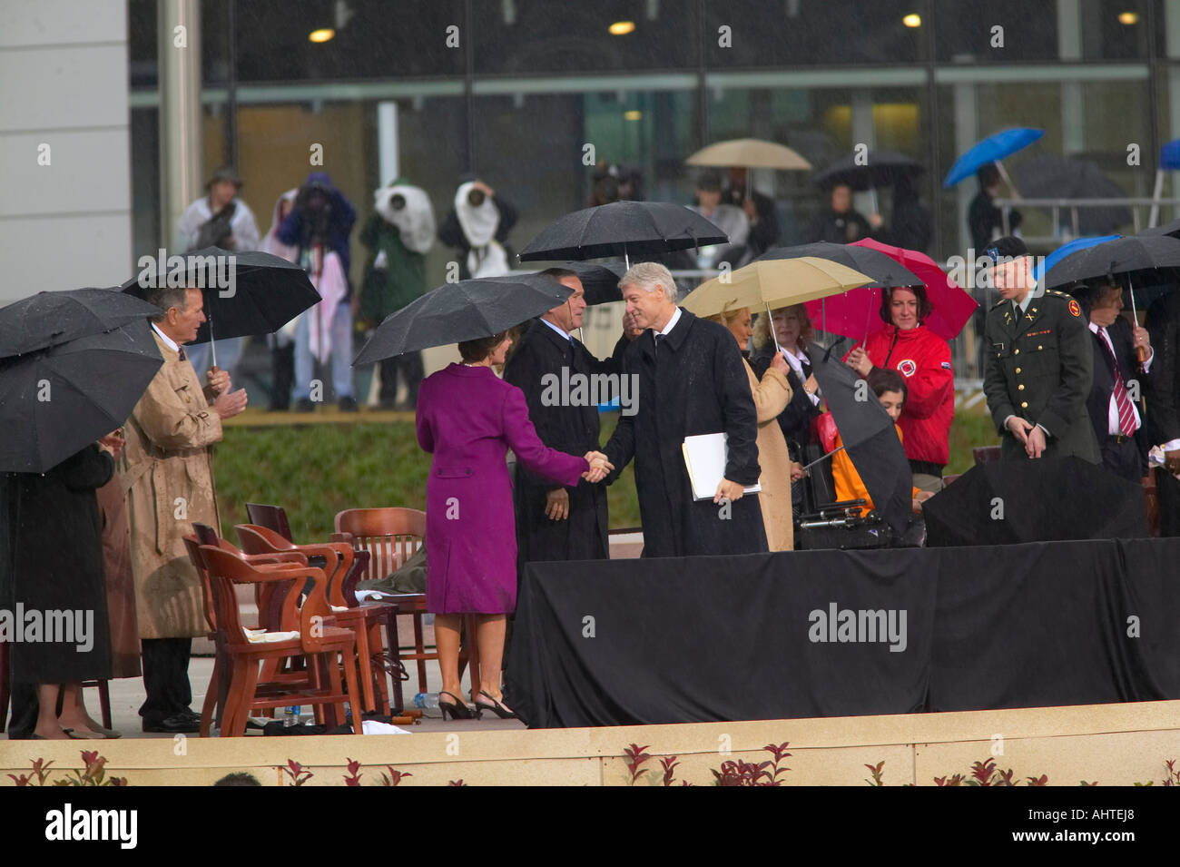 Former US President Bill Clinton shakes hands with Laura Bush during ...