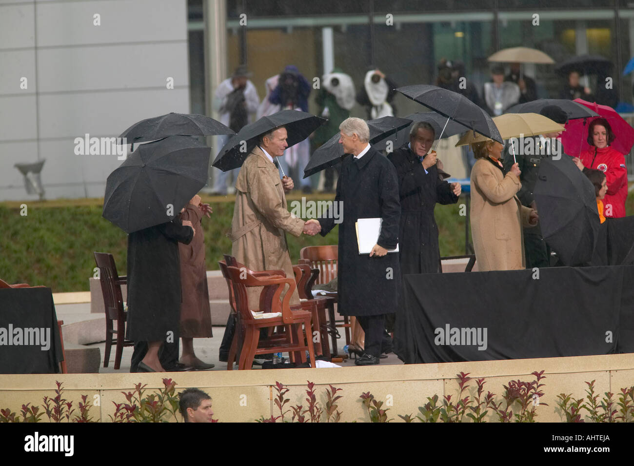 Former US President Bill Clinton shakes hands with former President ...