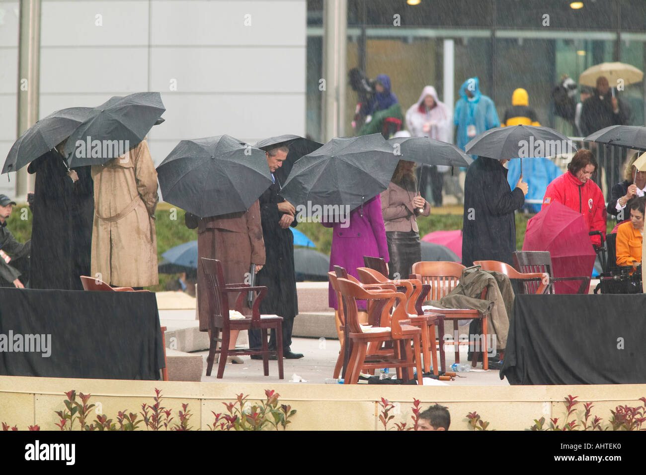 President George W Bush checks his watch on stage during the grand ...
