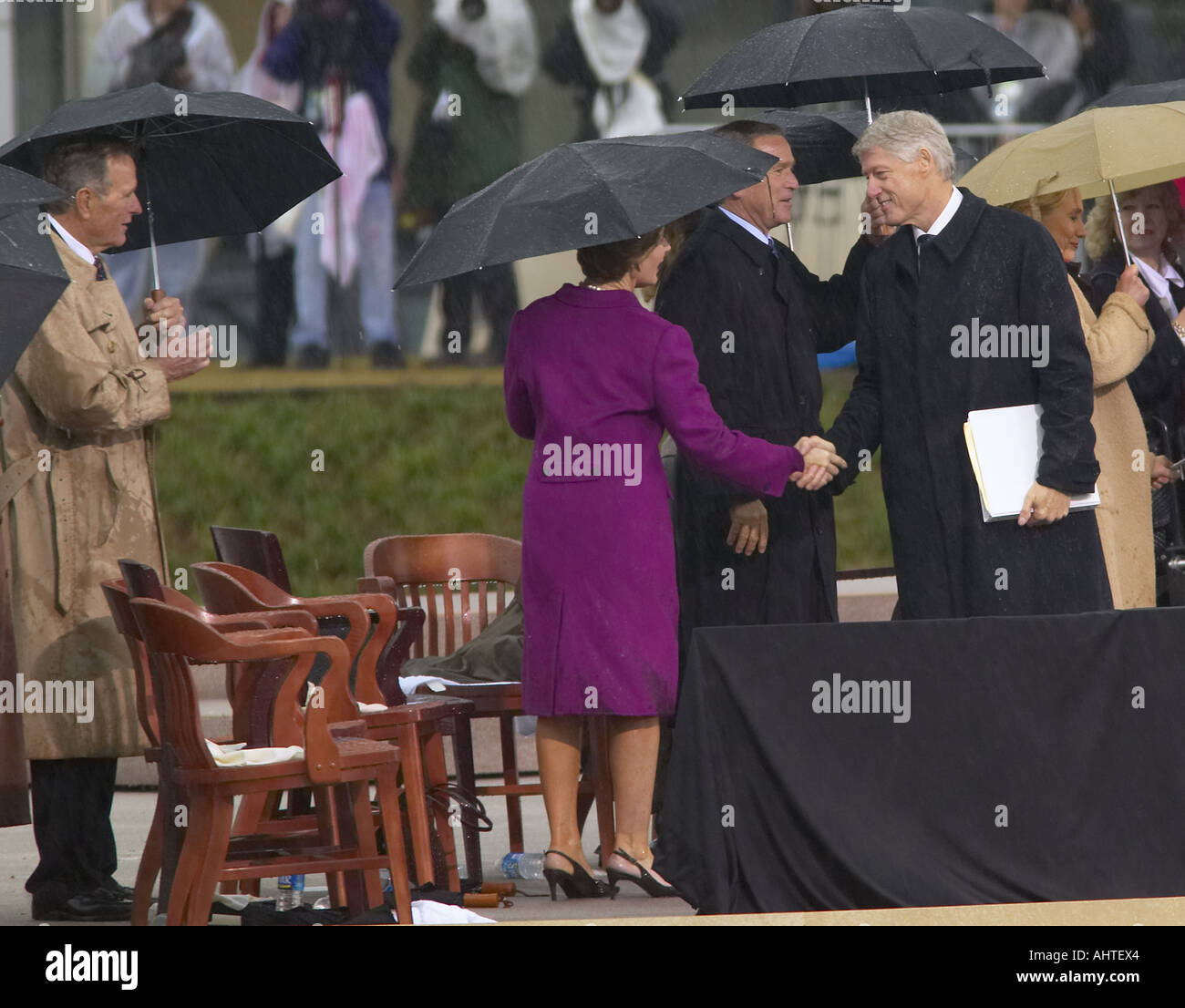 Former US President Bill Clinton shakes hands with Laura Bush during ...