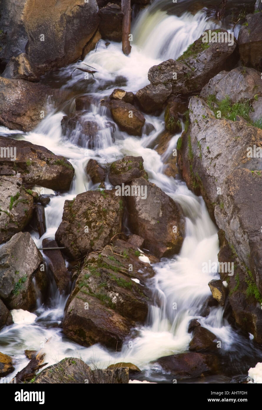 White water flowing around boulders at the base of a waterfall Stock ...
