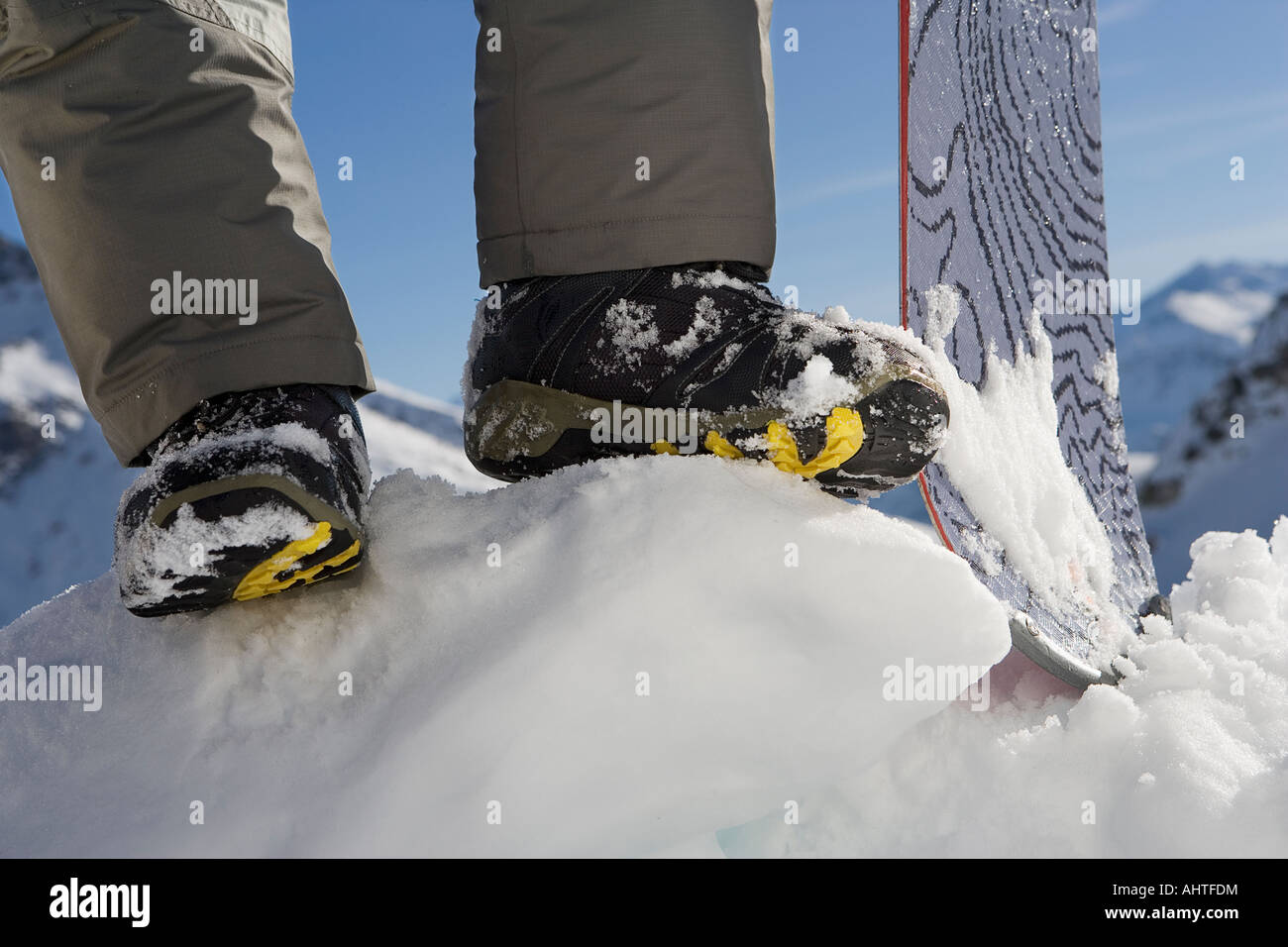 Snowboarder's feet and snowboard, low section Stock Photo - Alamy