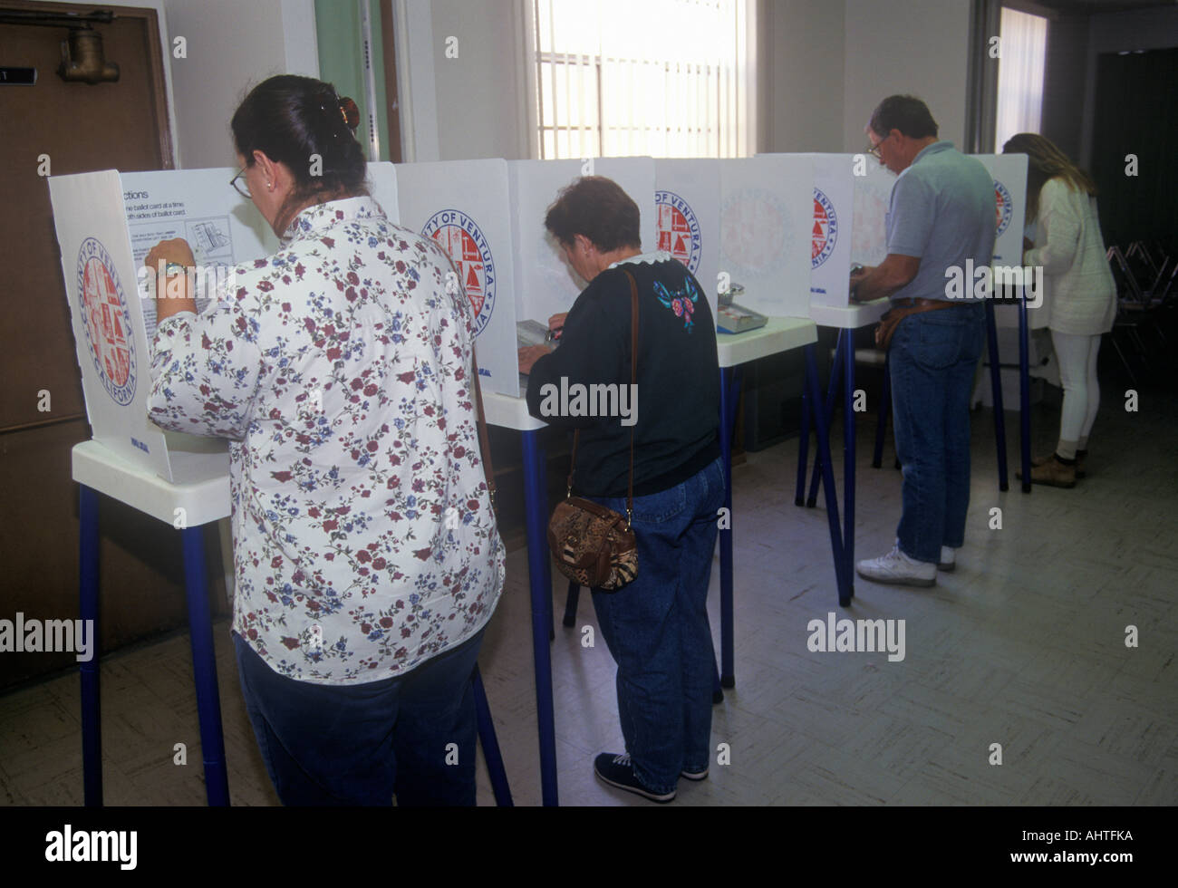 Voters and voting booths in a polling place CA Stock Photo - Alamy