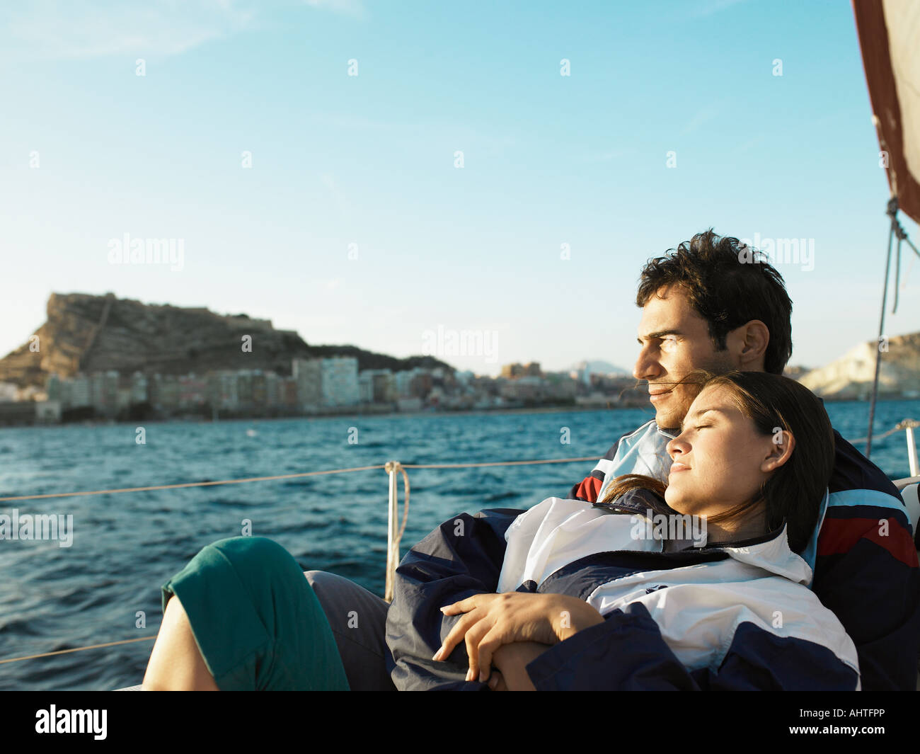 Young couple on yacht, sitting, portrait Stock Photo - Alamy