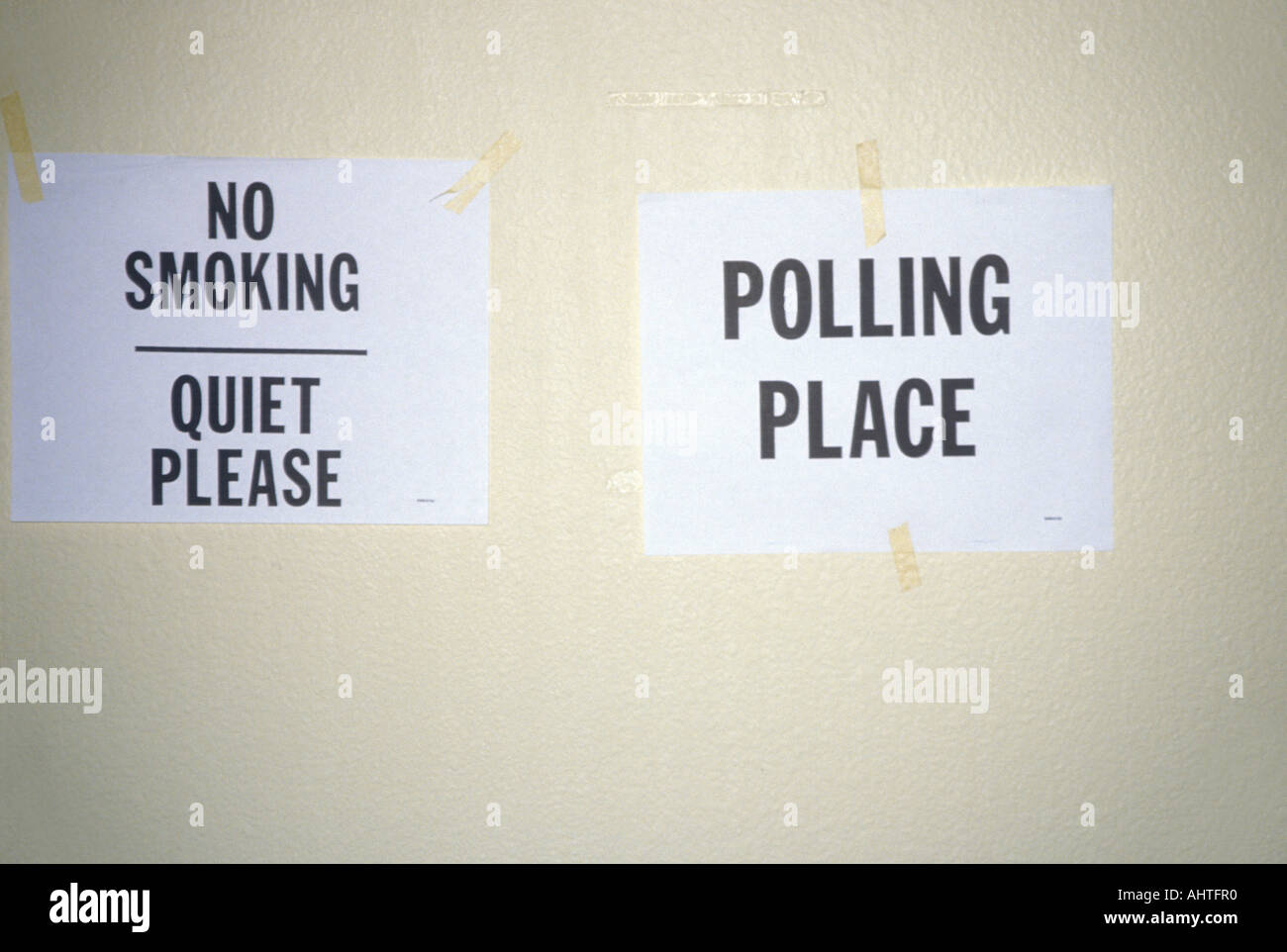 Signs taped to the wall in a polling place read No Smoking and Polling ...