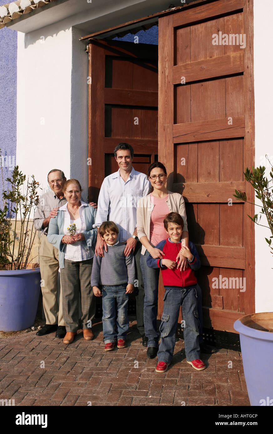 Family standing in front of house hi-res stock photography and images ...