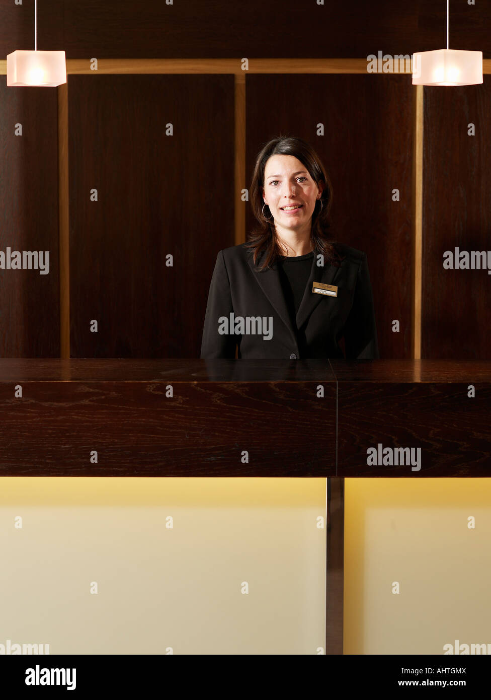 Young female hotel receptionist, smiling, portrait Stock Photo - Alamy