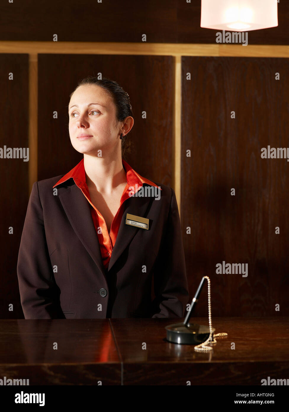 Young female hotel receptionist Stock Photo - Alamy