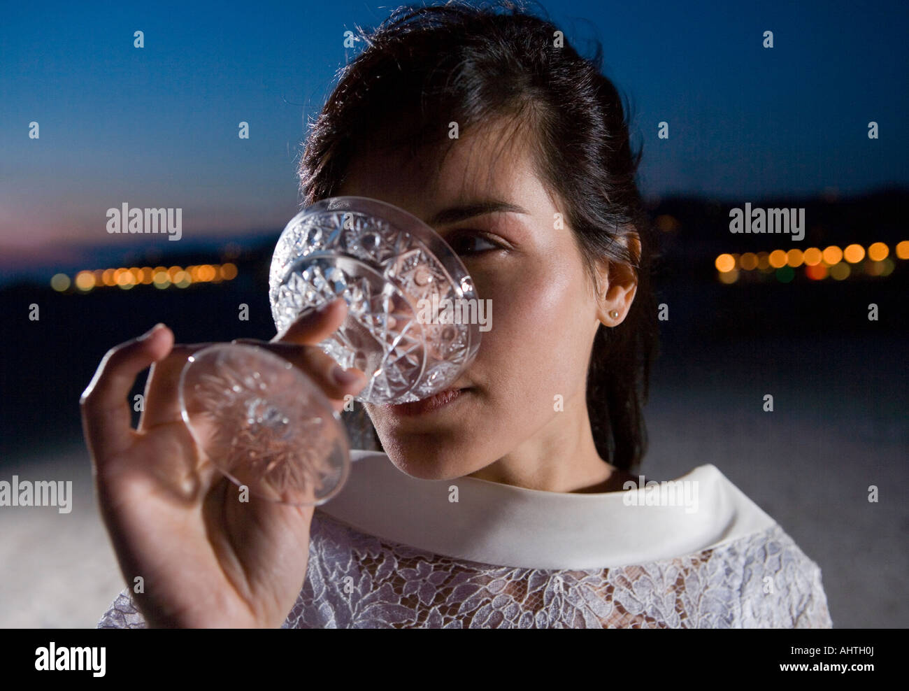 Young bride drinking champagne on beach, close-up, dusk Stock Photo - Alamy