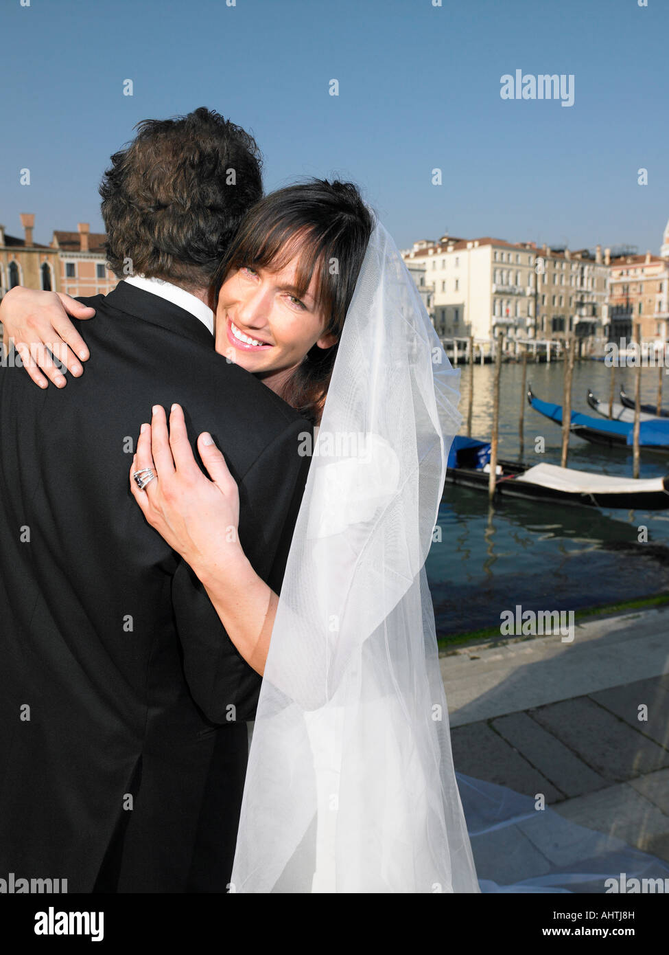 Italy, Venice, bride and groom embracing, woman smiling Stock Photo - Alamy