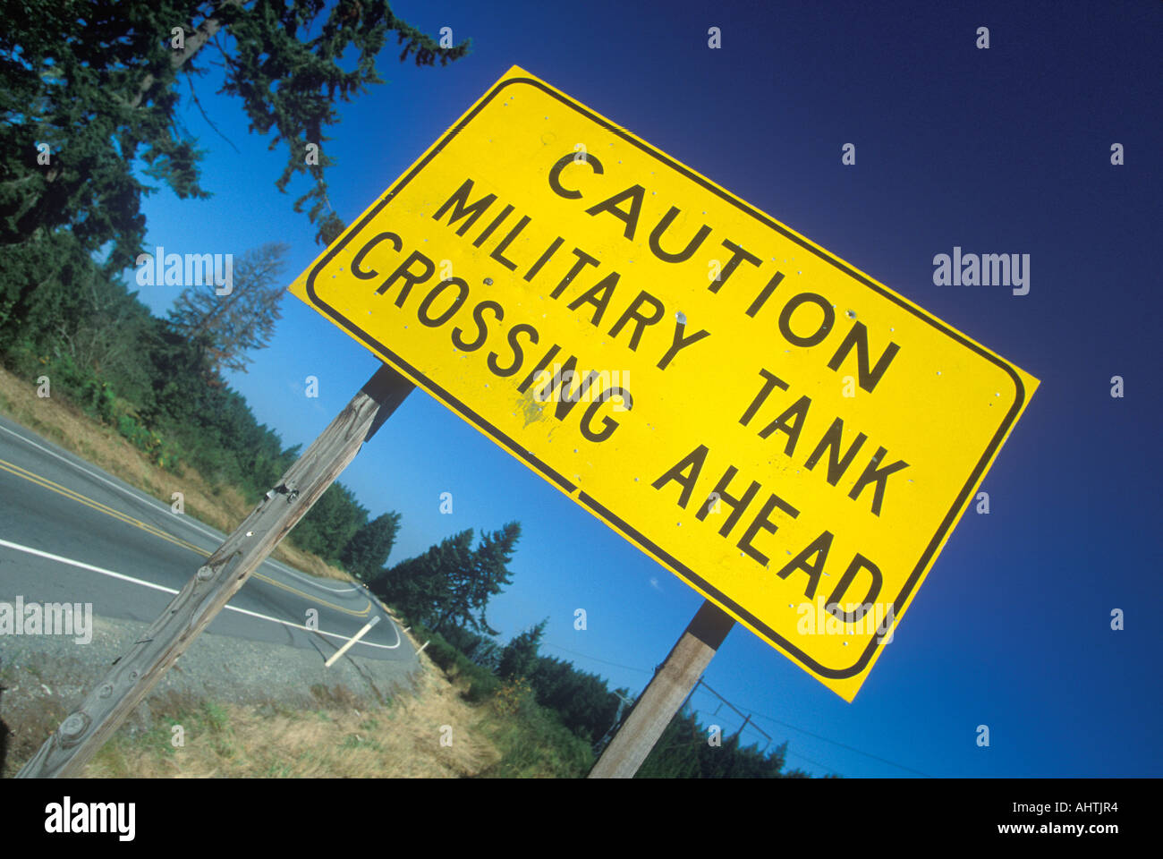 A sign that reads Caution Military tank crossing ahead Stock Photo - Alamy