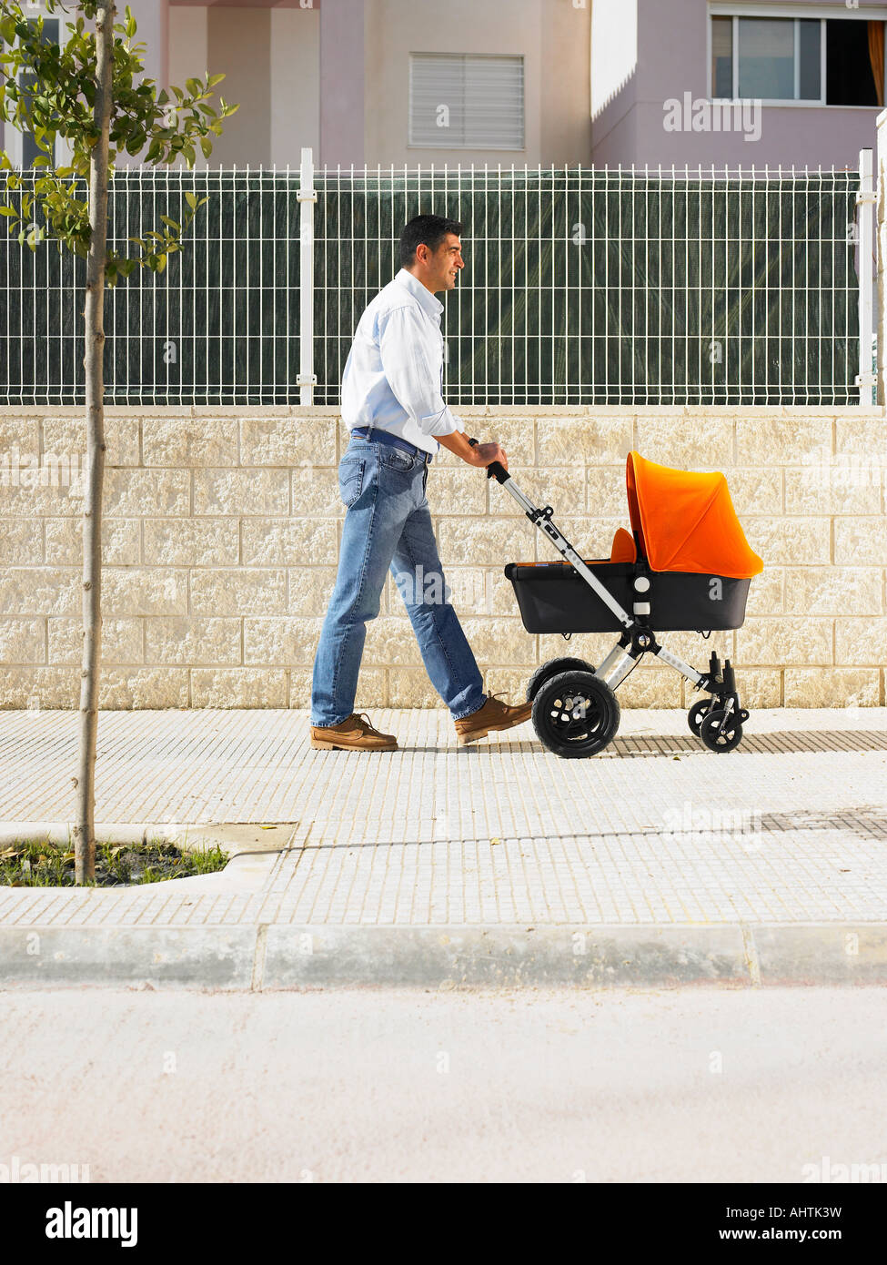 Father pushing pram on pavement, Alicante, Spain Stock Photo - Alamy