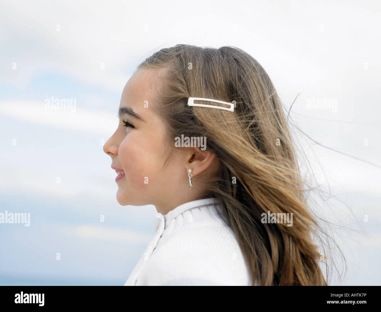Young girl (6-8) in the wind, profile, close-up. Alicante, Spain Stock ...