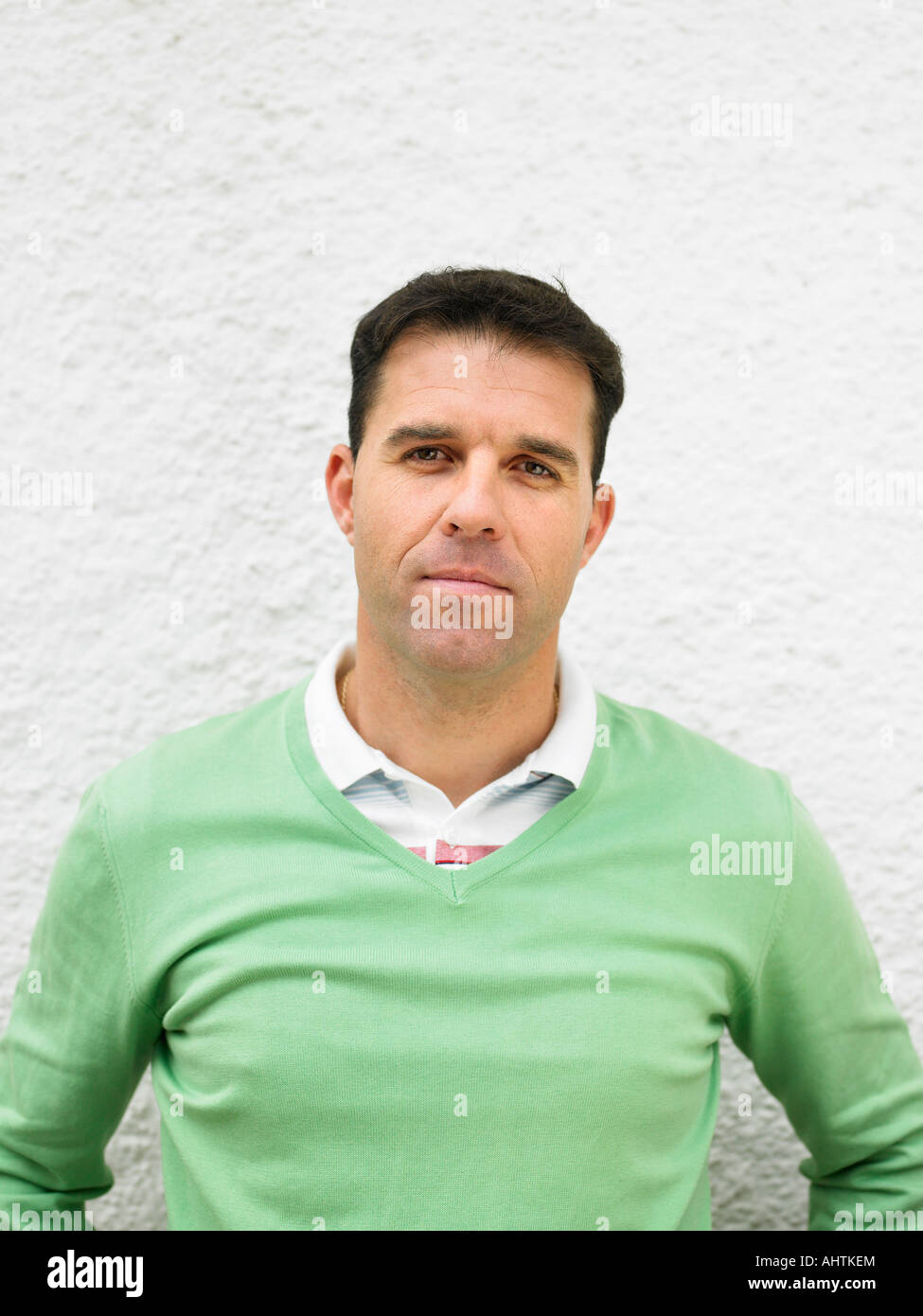Man standing by wall, portrait Stock Photo - Alamy