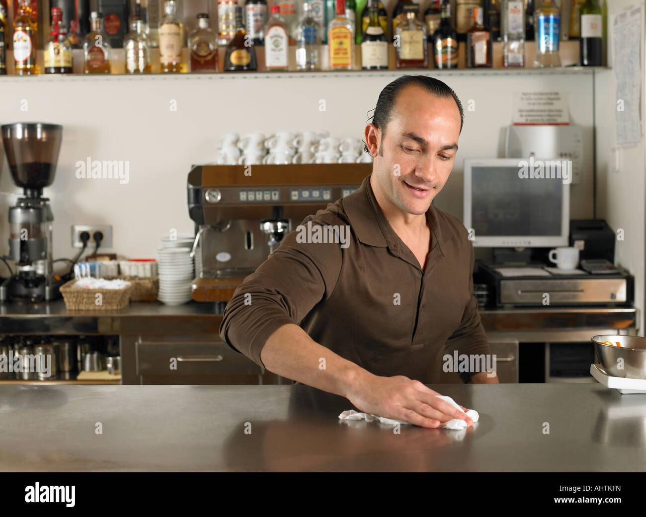 Barista polishing the counter in café. Alicante, Spain Stock Photo - Alamy