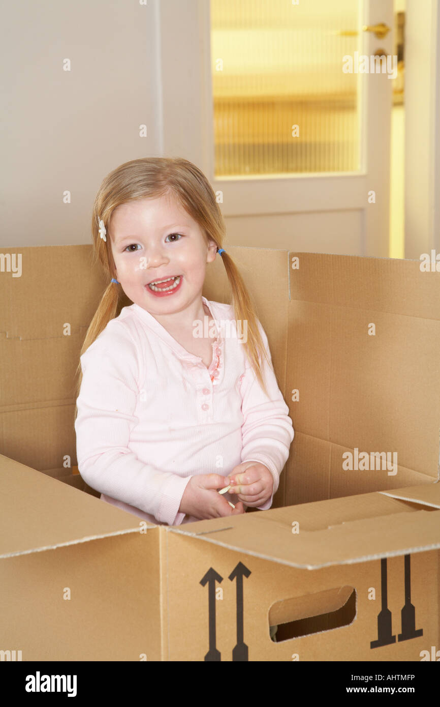 Girl (3-5) standing in cardboard box smiling, portrait Stock Photo - Alamy