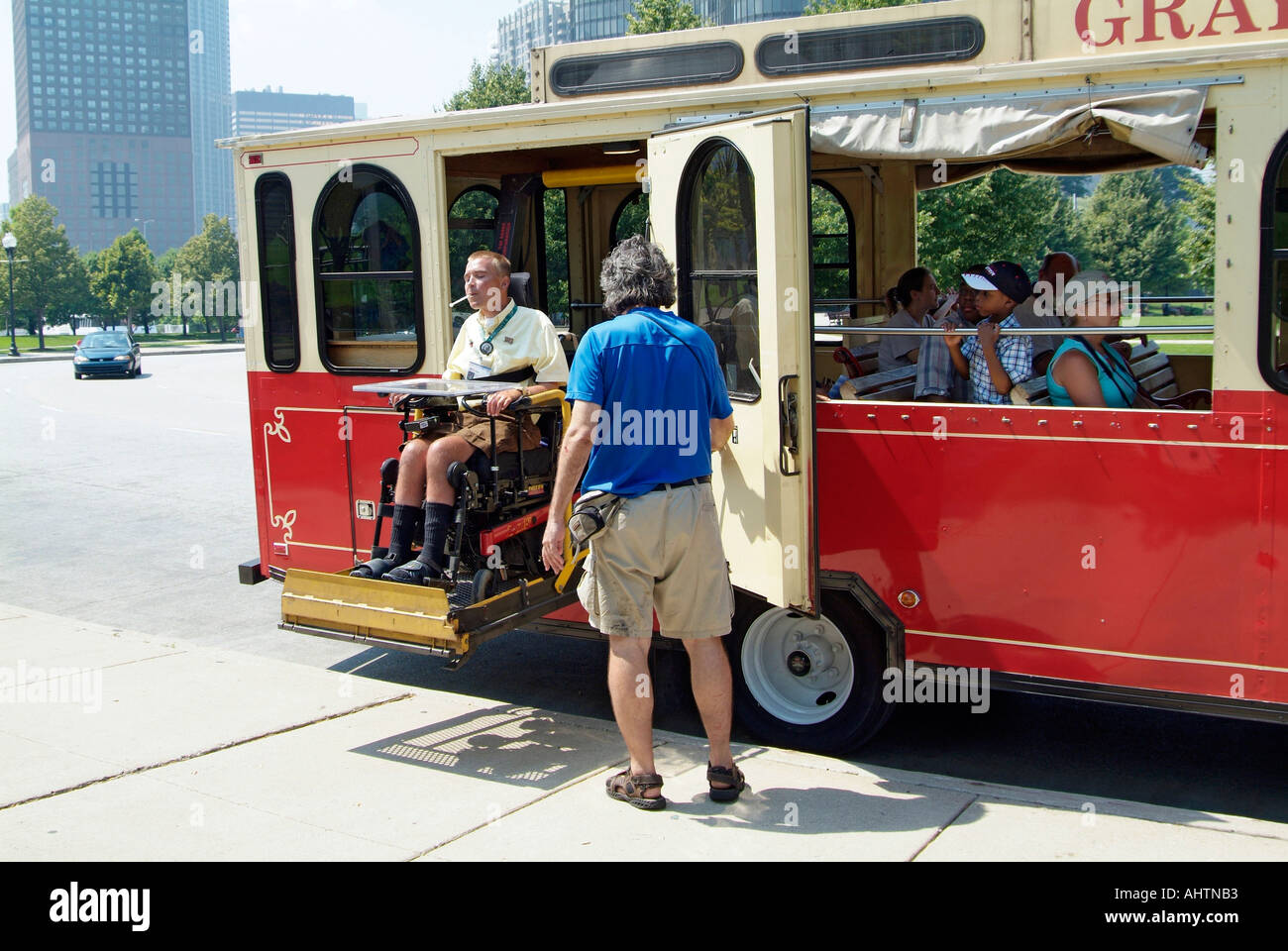 Handicapped male in a wheel chair boards a special needs bus at the ...