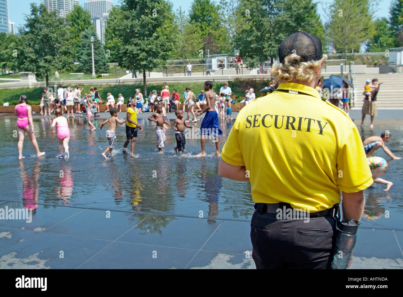 Security guard protects children in a water park in downtown Chicago ...
