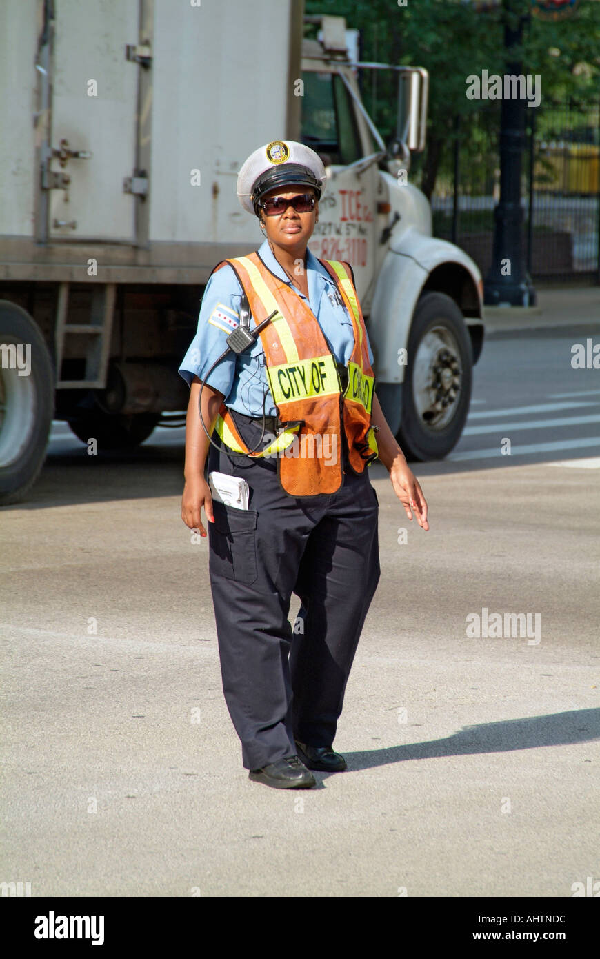 Traffic police direct pedestrian and automobile traffic in busy ...