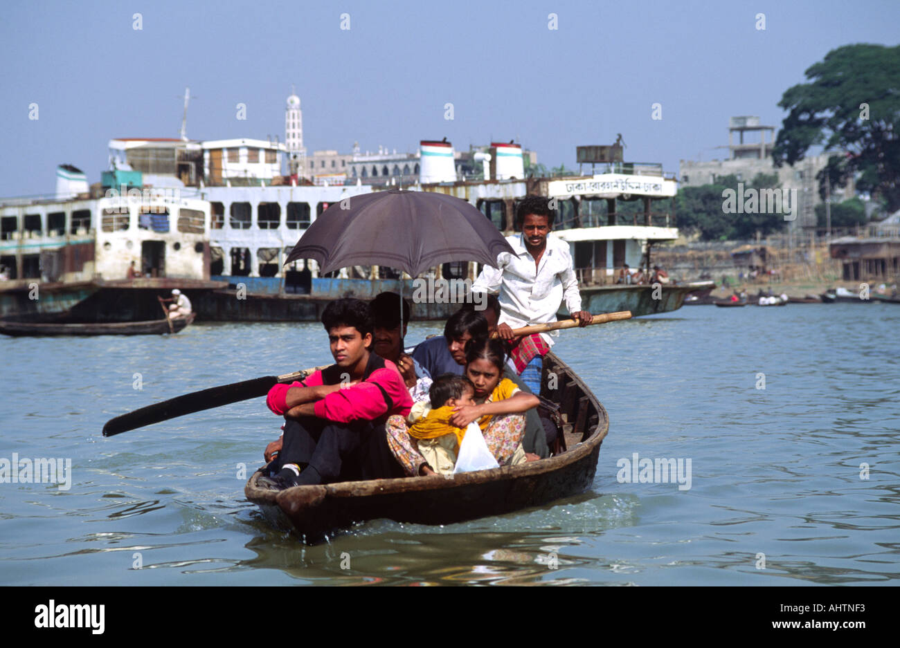 Small rowing boat river ferry with passengers crossing the Padma River ...
