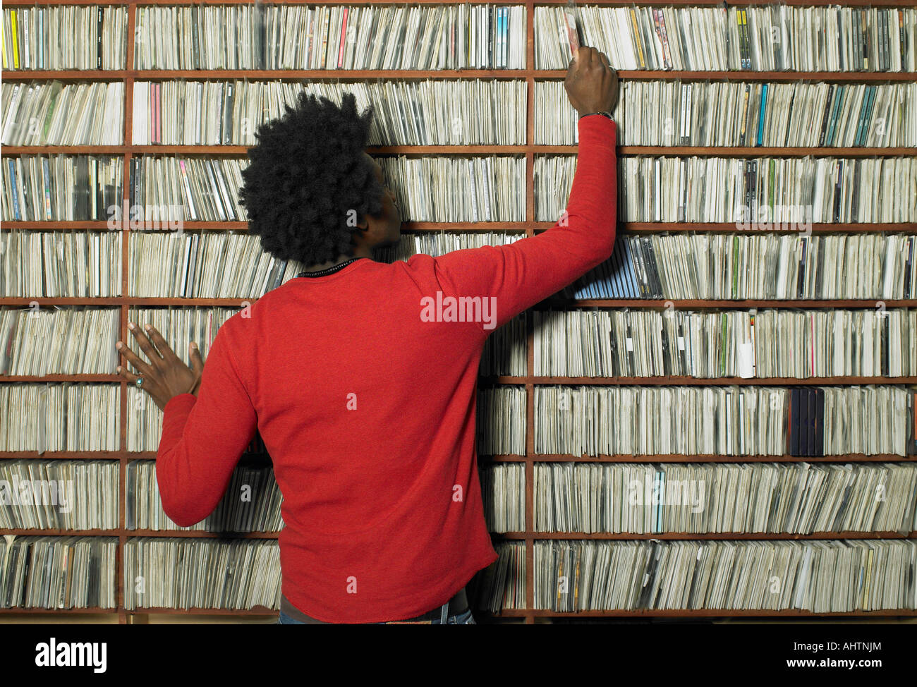Man choosing compact disc from shelf in music shop, rear view Stock ...