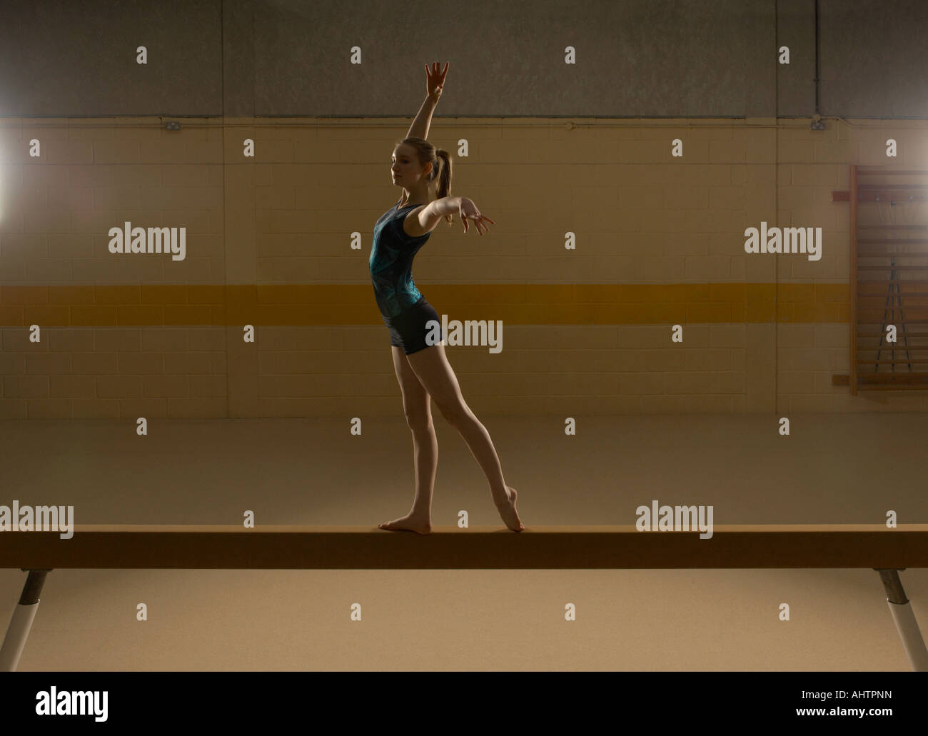 Teenage gymnast (16-18) performing on balance beam Stock Photo - Alamy