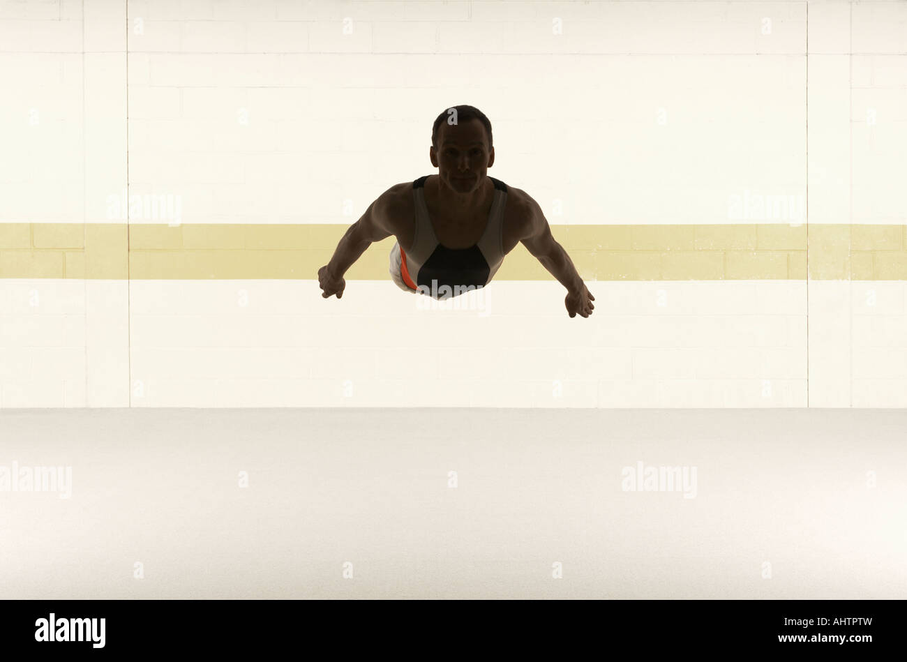 Male gymnast performing somersault in floor exercise Stock Photo - Alamy