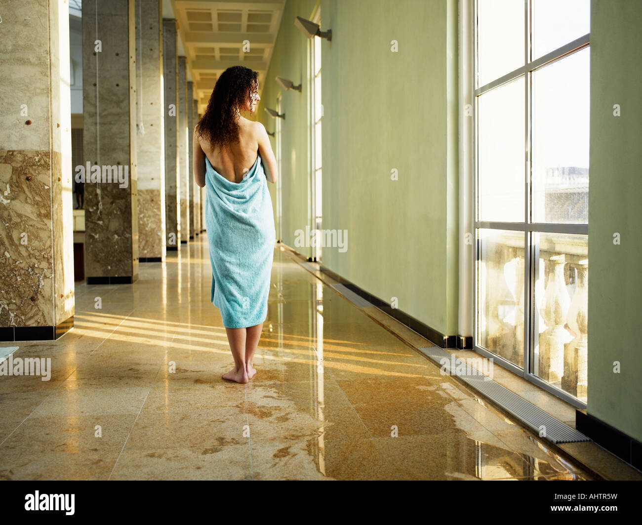 Woman wrapped in towel, rear view Stock Photo - Alamy