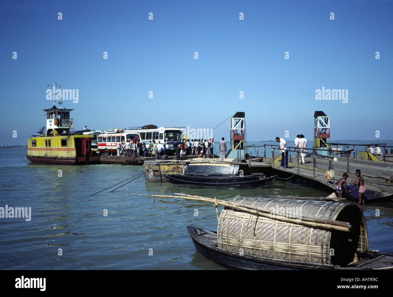A vehicle and passenger ferry unloading at the jetty and river gypsy ...