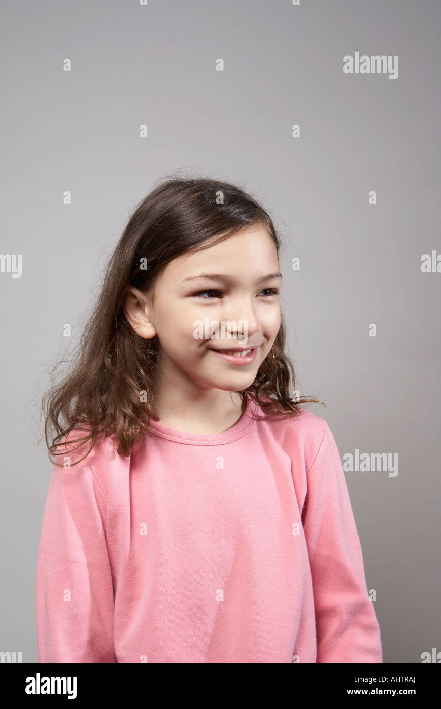 Girl (5-7) smiling looking away Stock Photo - Alamy