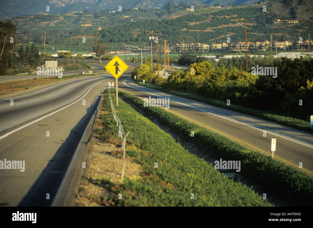 A merge sign on a highway Stock Photo - Alamy