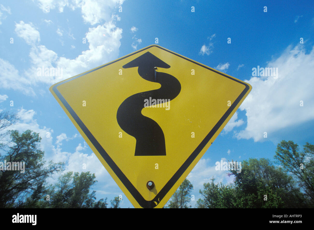 Windy road sign Stock Photo - Alamy