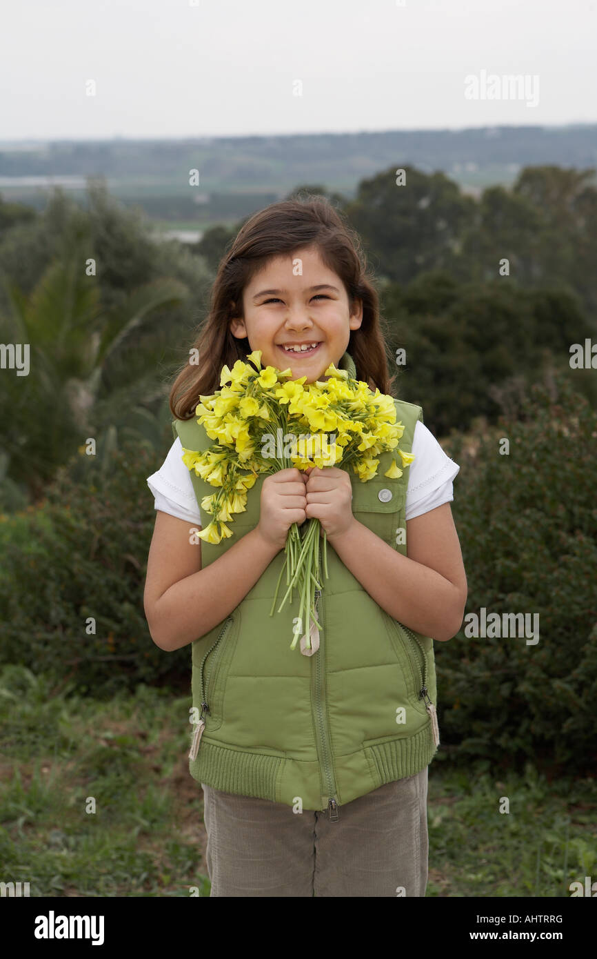 Girl (6-8) holding bunch of flowers, portrait Stock Photo - Alamy