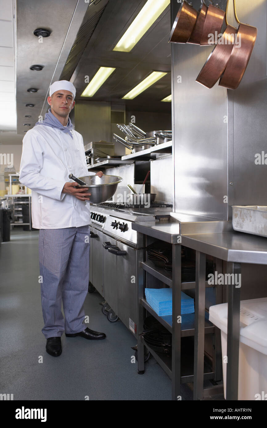 Chef holding bowl in his kitchen Stock Photo - Alamy