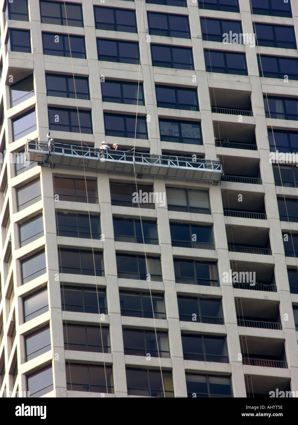 Window washers work at extreme heights to clean windows on tall ...