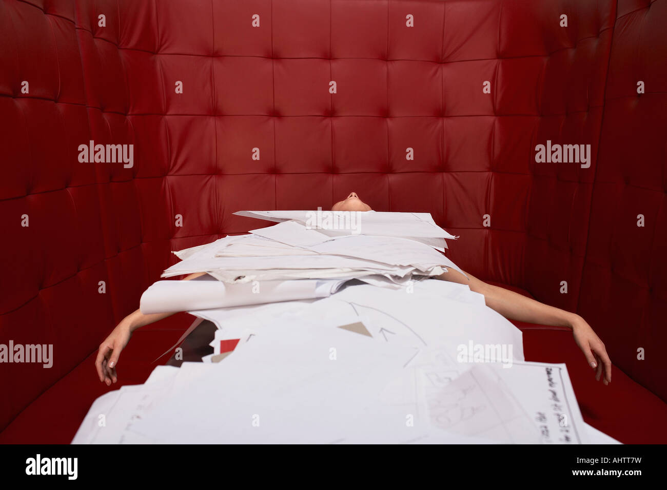 Businesswoman lying on table with red seating Stock Photo - Alamy