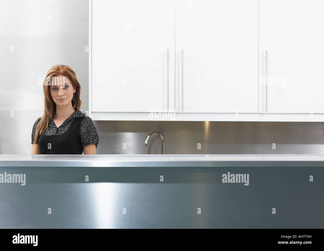 Woman in staff kitchen Stock Photo - Alamy