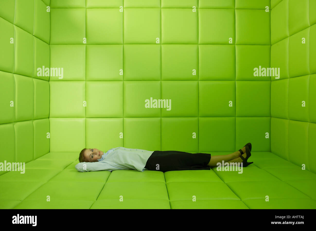 Woman lying in green padded cell Stock Photo - Alamy