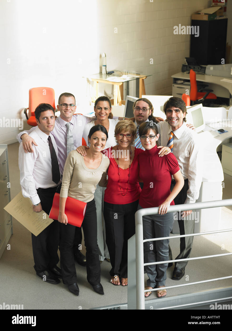 Staff standing together in a group Stock Photo - Alamy