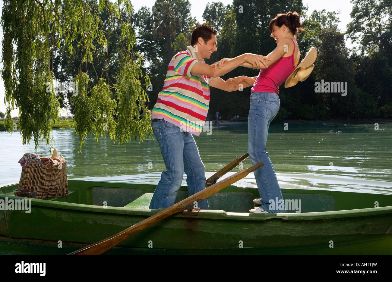 Man and woman balancing on boat Stock Photo - Alamy