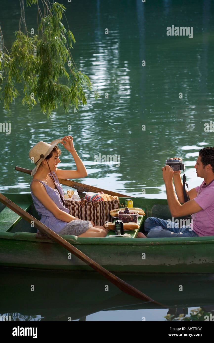 Man filming a woman on boat Stock Photo - Alamy